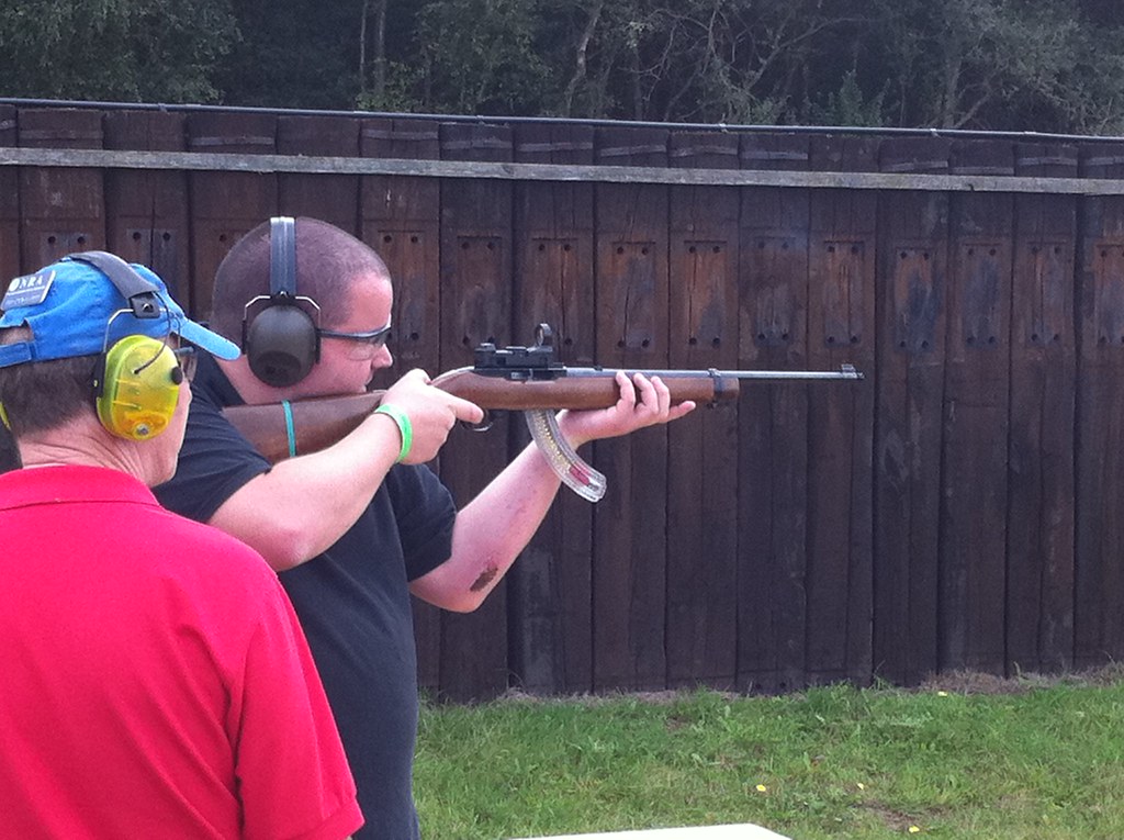 Mark East firing a semi-automatic .22 rifle with laser sight | Trendy ...
